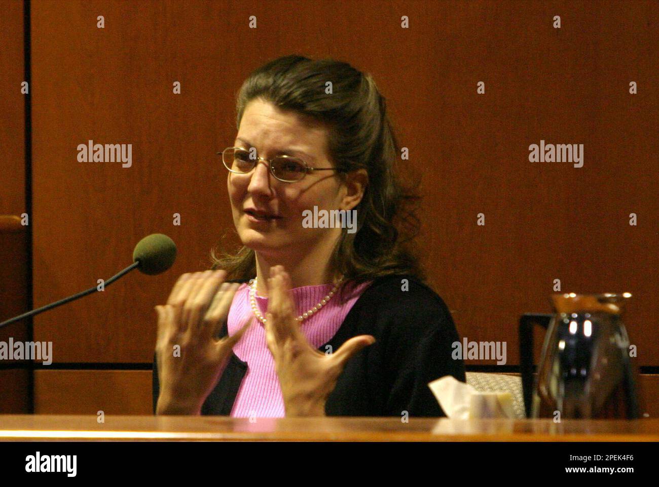 Wendi Andriano shows how she pulled a phone cord that was wrapped ...