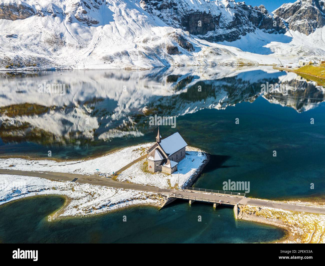 Aerial view of the Frutt Chapel at the lakeside of Melchsee Lake with ...