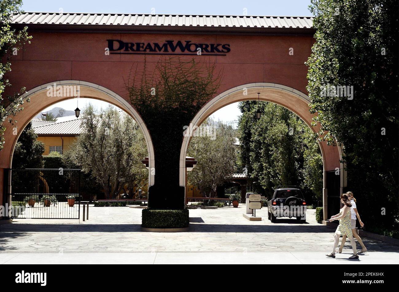 ** FILE ** People walk past the entrance to DreamWorks' studios in ...