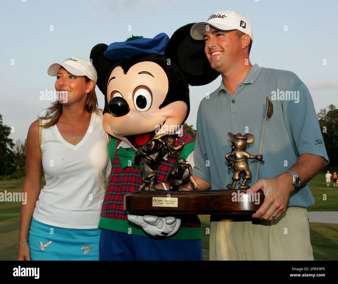 Ryan Palmer, right, holds the trophy as he poses with his wife Jennifer ...