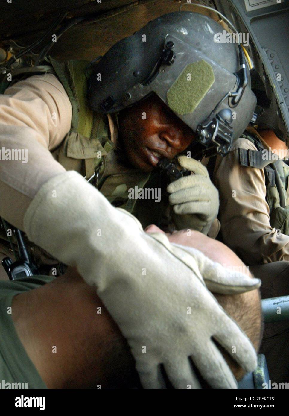 U.S. Army Medic Ssg. Tyrone Jordan examines a sick American soldier ...