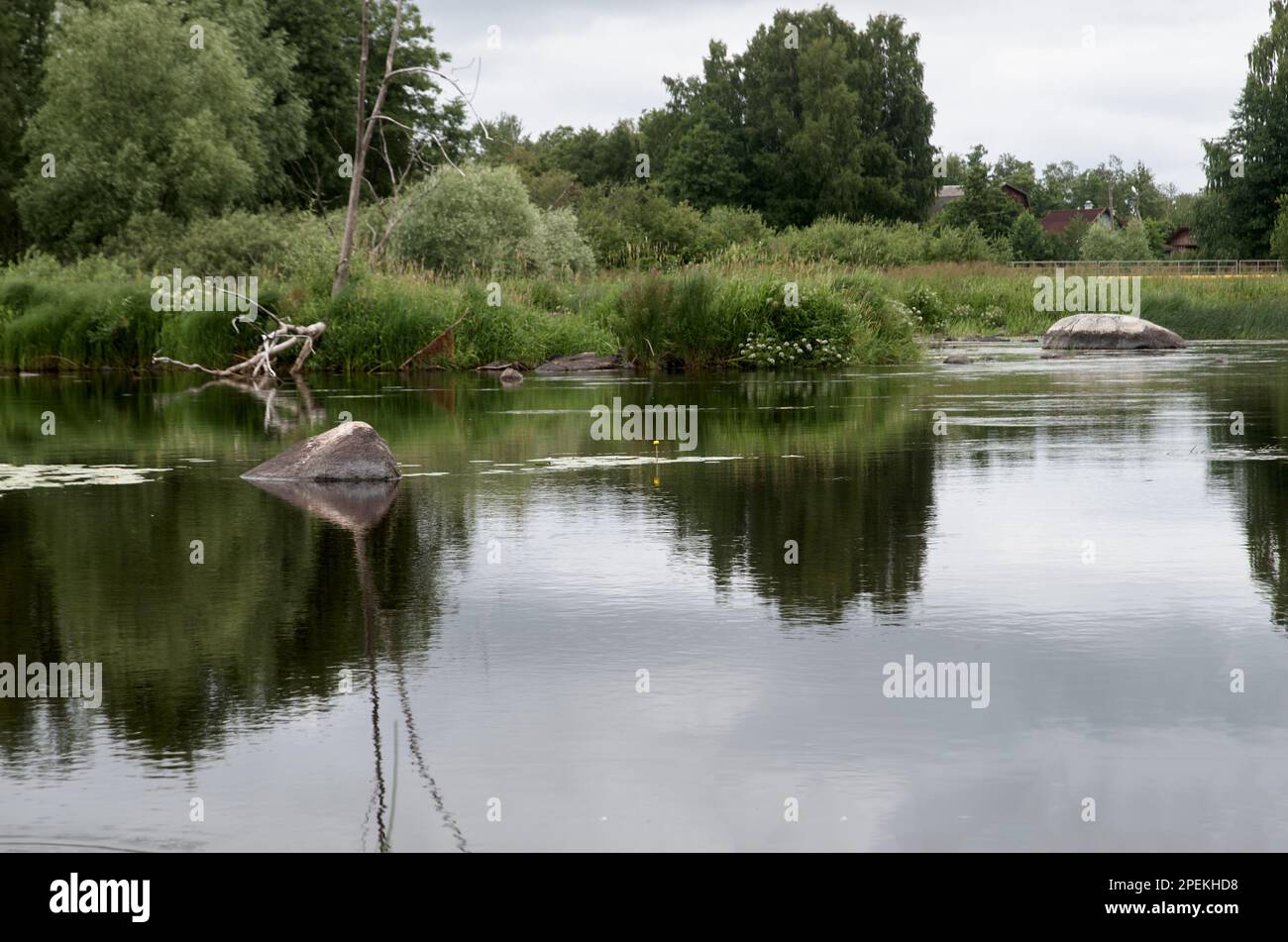 Summer landscape with lake, stones and forest Stock Photo - Alamy