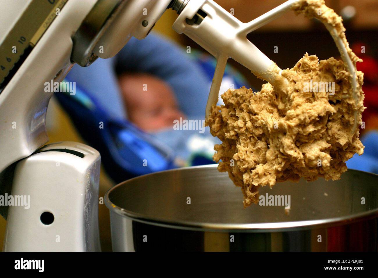 Cookie dough clinging to the beaters of a standing mixer demonstrates ...