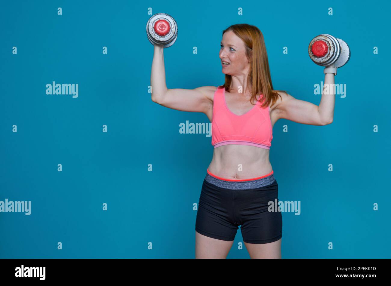 Woman doing triceps exercise dumbbells hi-res stock photography and ...