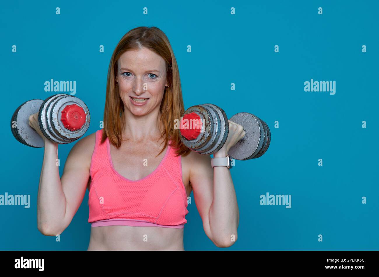 Woman doing triceps exercise dumbbells hi-res stock photography and ...