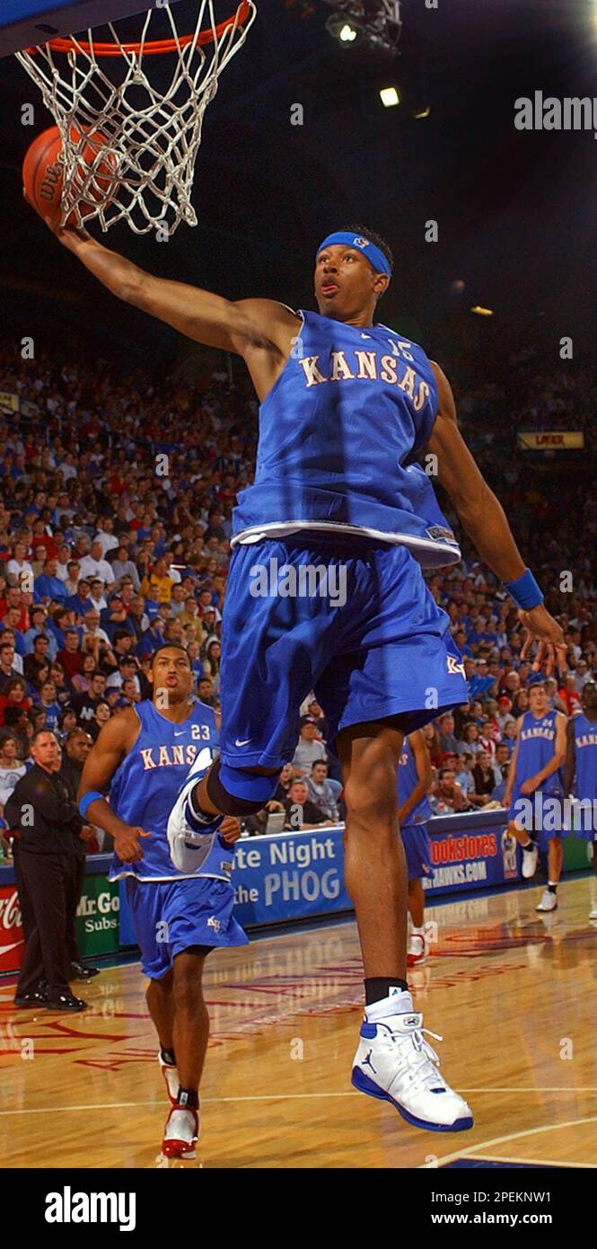 Kansas sophomore J.R. Giddens goes for a dunk as Wayne Simien trails in ...