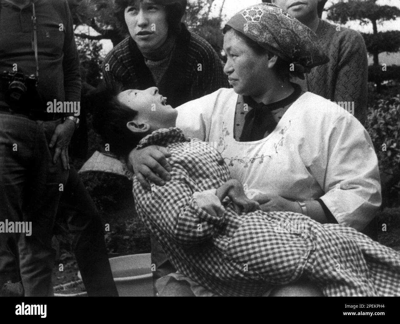 **FILE** A woman holds a victim of "Minamata Disease", or mercury ...