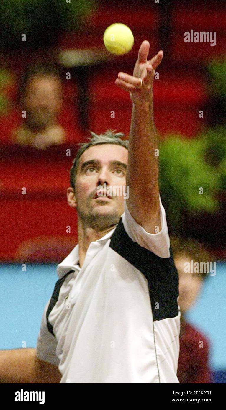 Italy's Davide Sanguinetti serves to Nicholas Massu from Chile, on ...