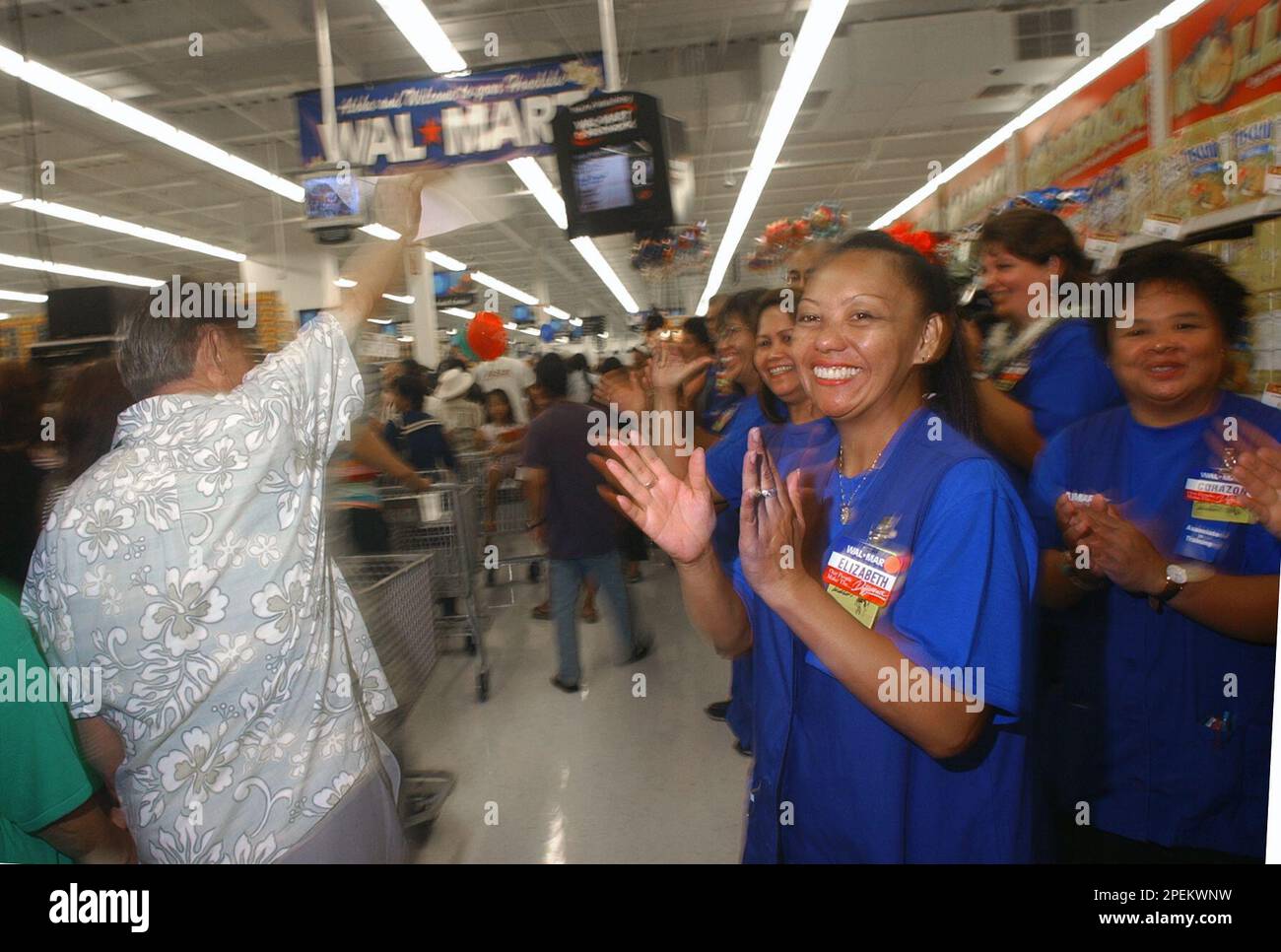 Elizabeth Lorenzo of Honolulu, right, a cashier in Hawaii's largest Wal ...