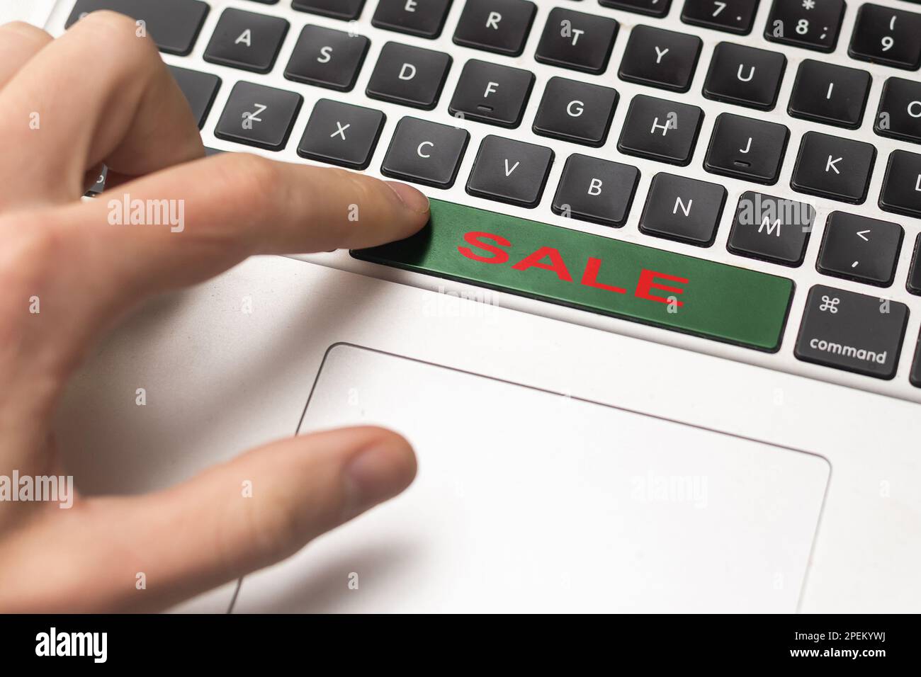 The finger pressing the sell button on the computer keyboard, believing ...