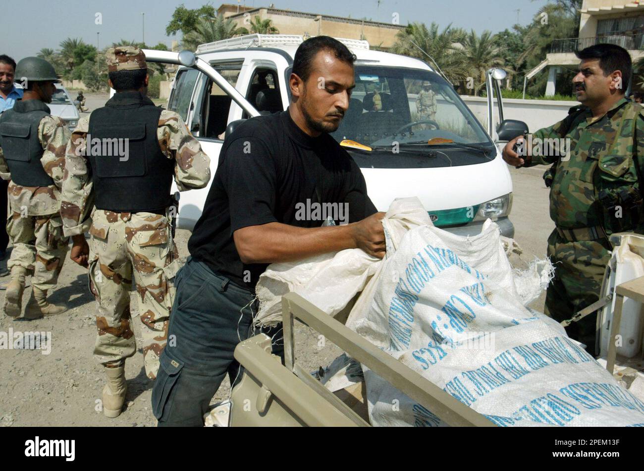 A militia member loyal to Shiite cleric Muqtada al Sadr delivers sacks ...