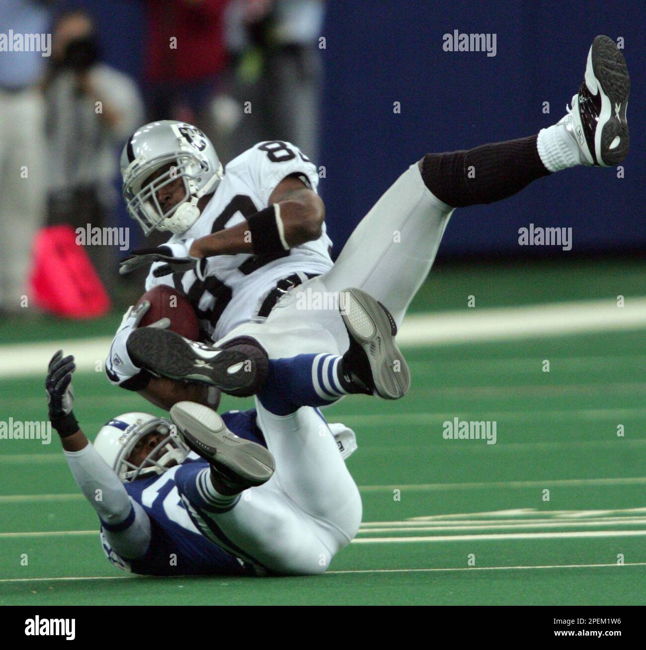 Oakland Raiders' Ronald Curry (89) is brought down by Indianapolis ...