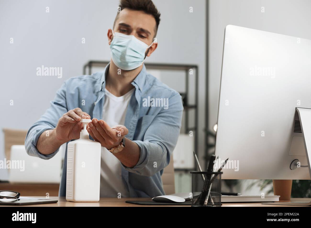 Man applying sanitizer in office, focus on hands. Personal hygiene ...