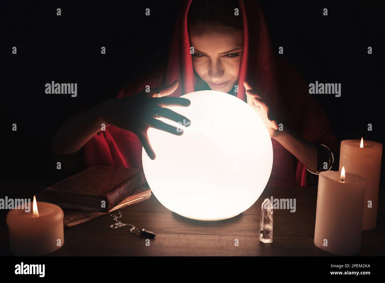 Soothsayer Using Glowing Crystal Ball To Predict Future At Table In