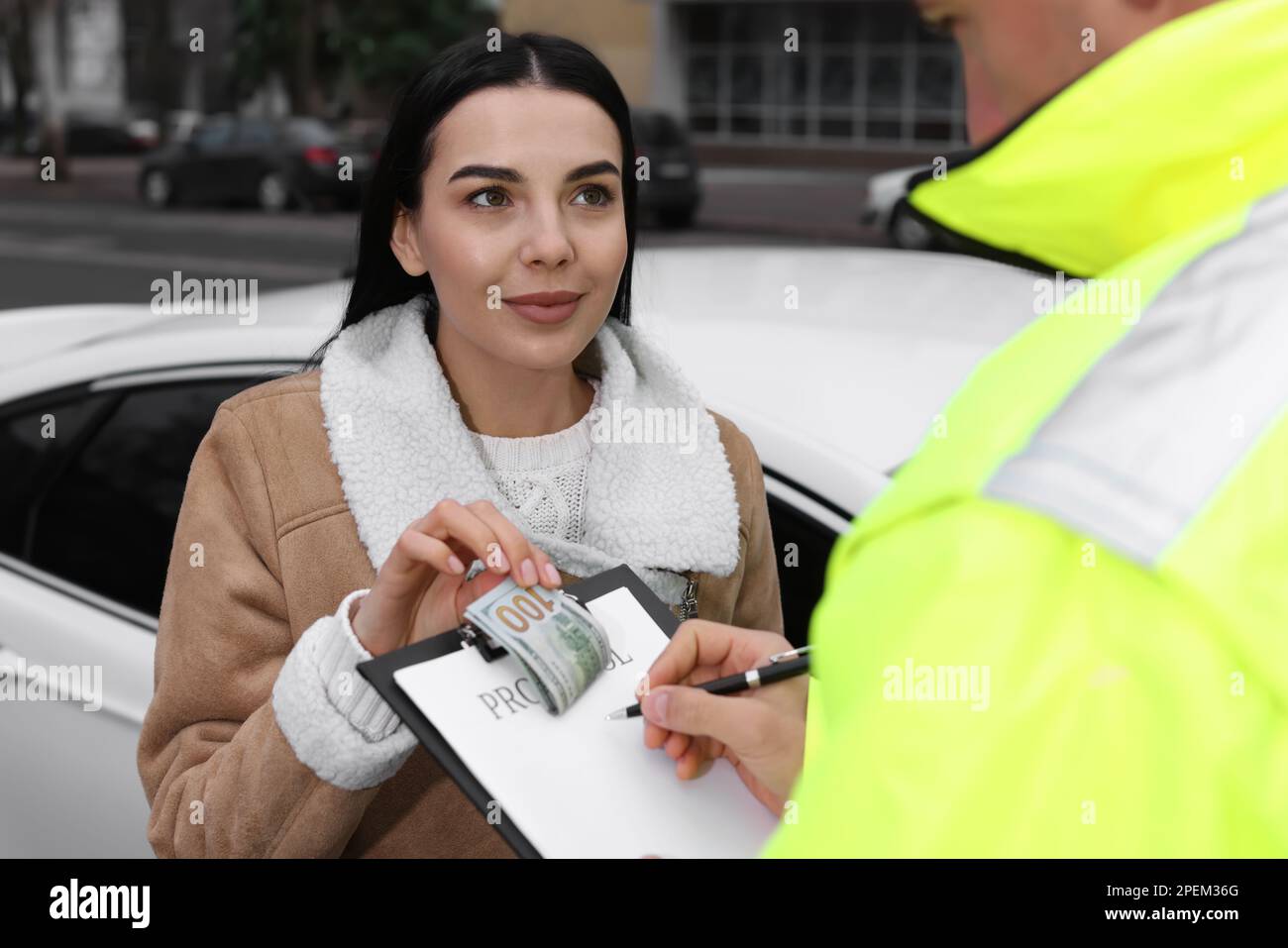 Woman giving bribe to police officer near car outdoors Stock Photo - Alamy