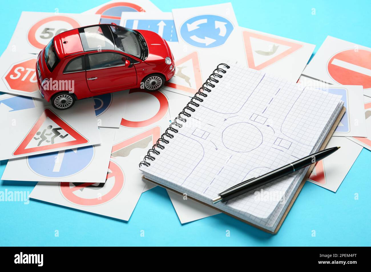 Many different road sign cards, notebook with sketch of roundabout and ...