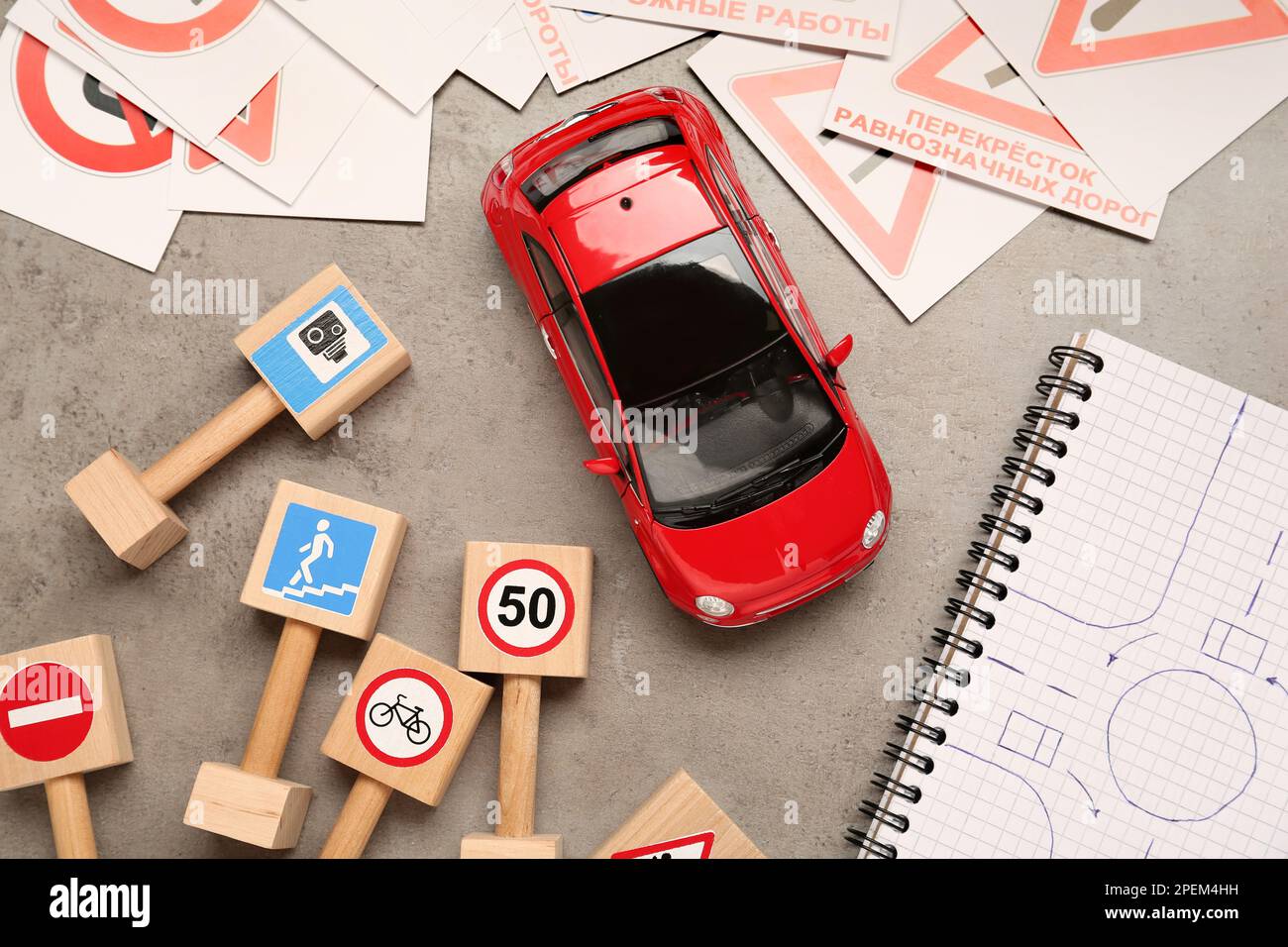 Many different road signs, notebook with sketch of roundabout and toy ...