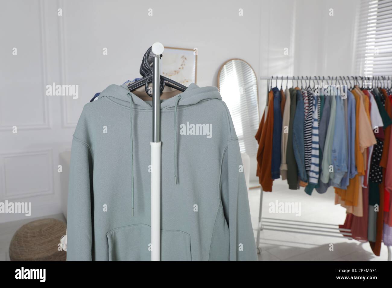 Racks with stylish clothes indoors. Fast fashion Stock Photo - Alamy