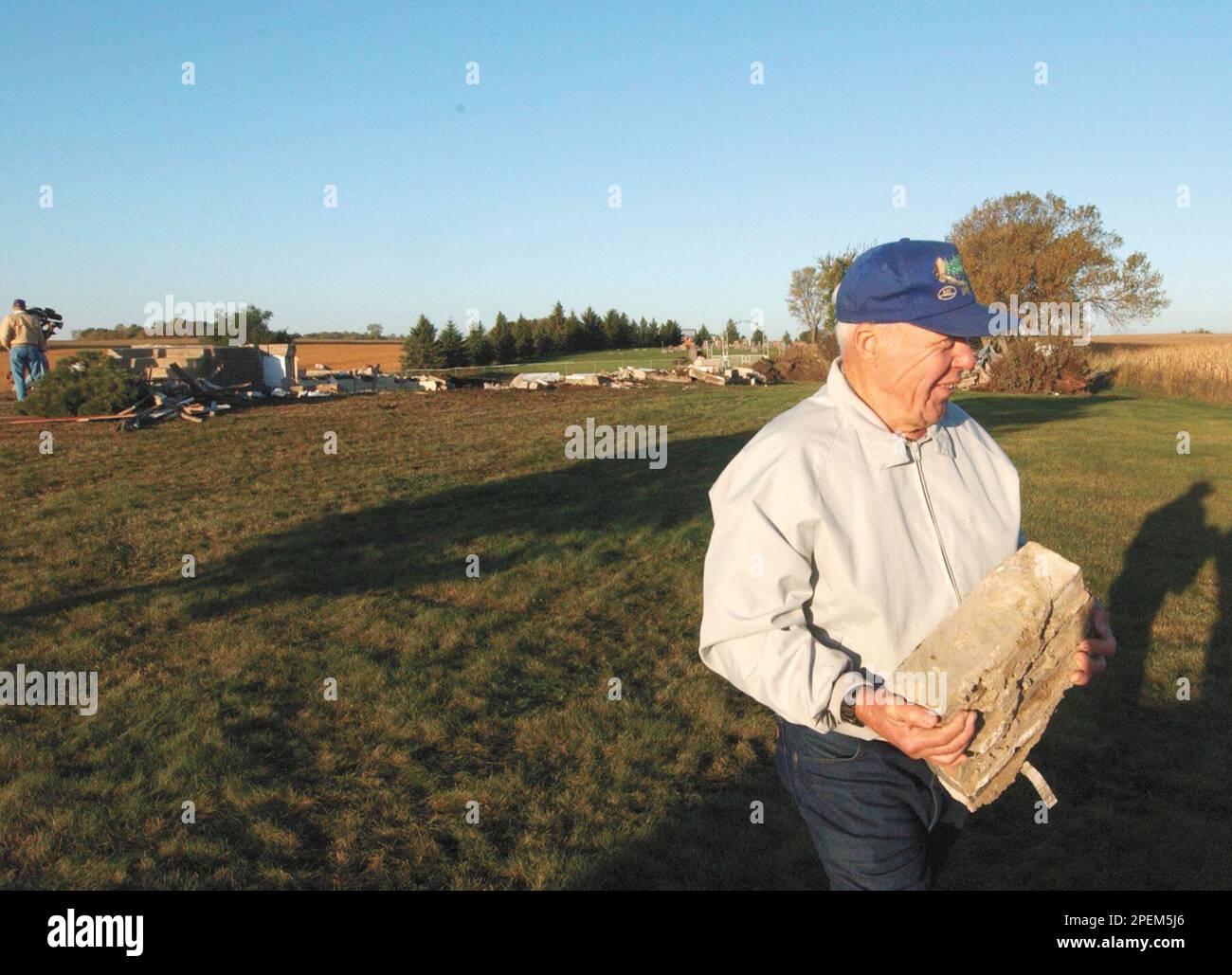 Roger Nelson takes a chunk of brick from the foundation of the 75 year ...