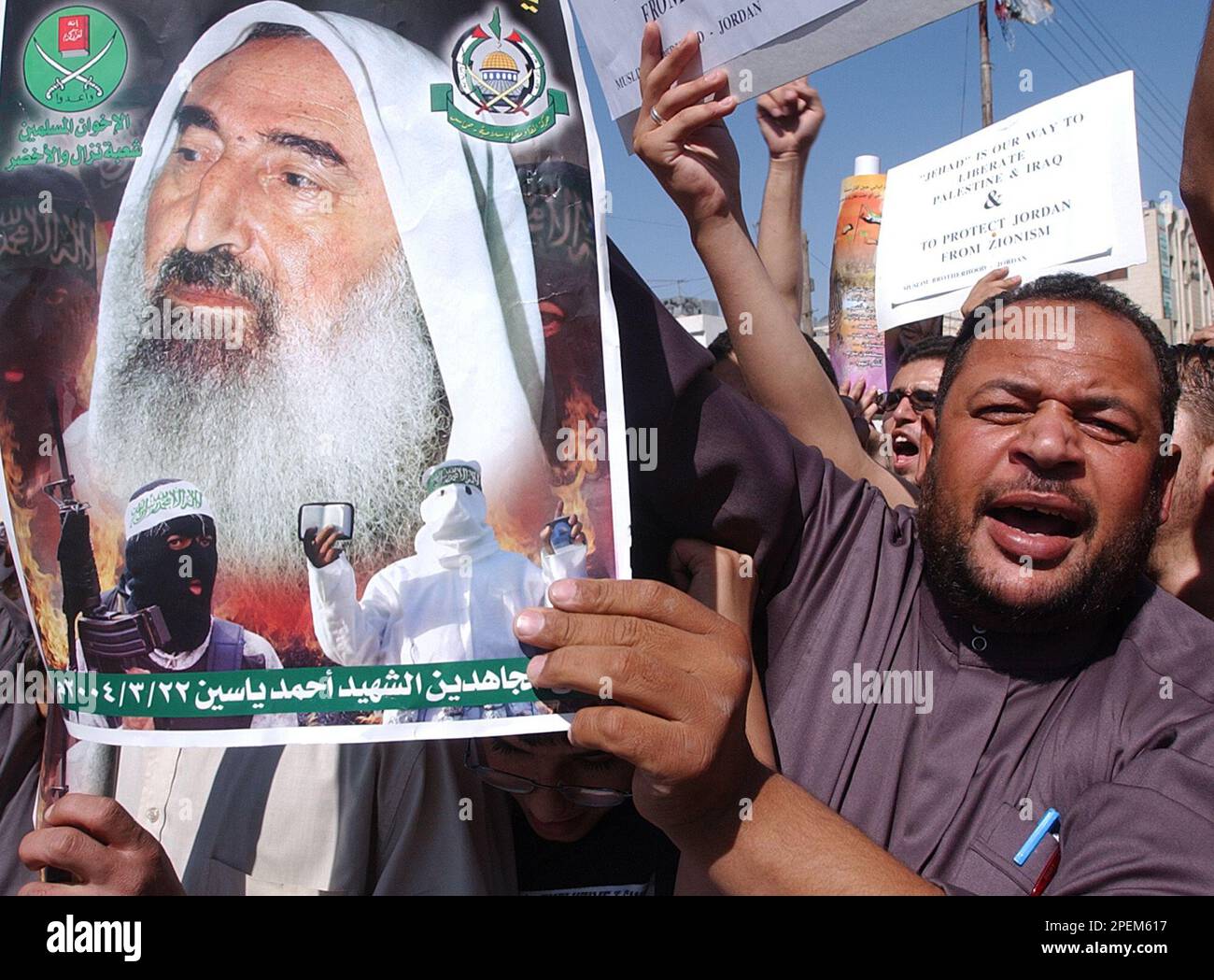 Islamic Action Front protester holds up a portrait of Hamas ...
