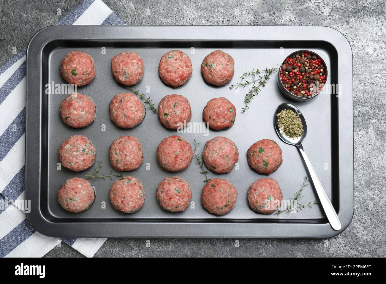 Many fresh raw meatballs on grey table, top view Stock Photo - Alamy