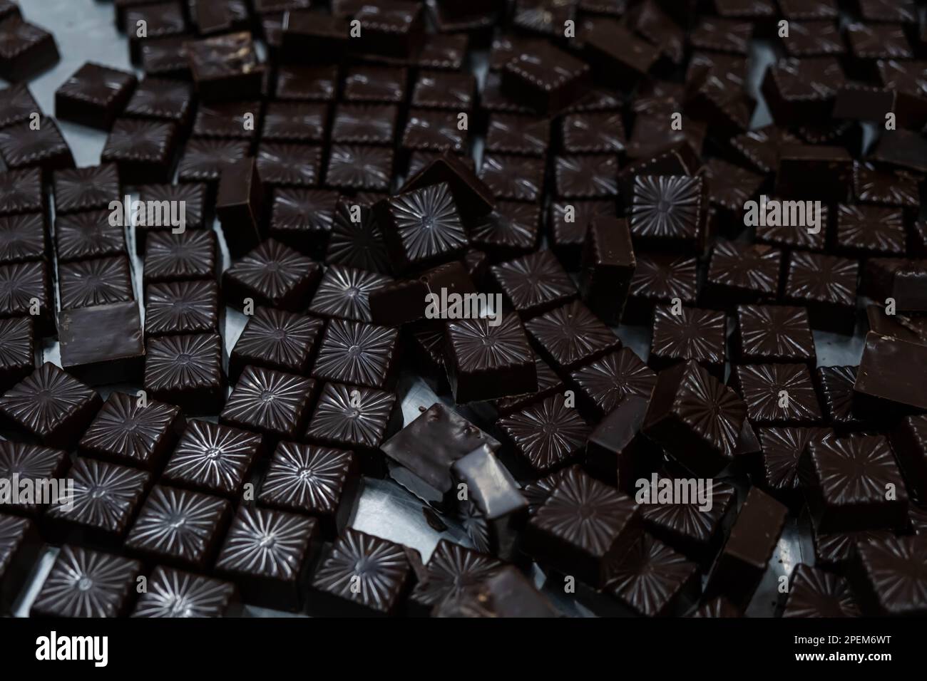 Chocolate candies processing on conveyor at confectionery shop Stock ...