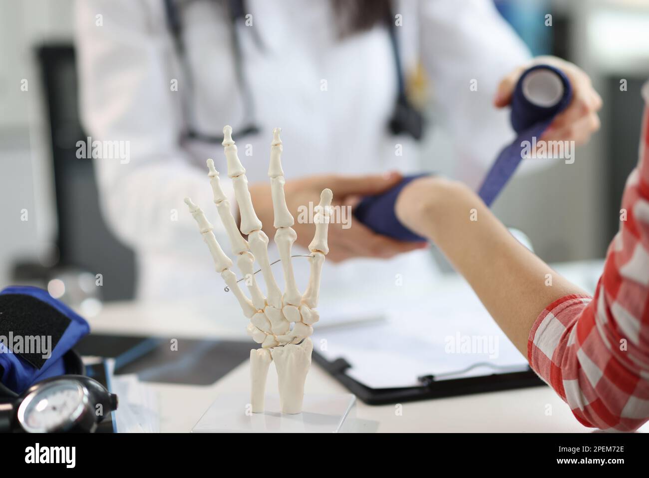 Hands of traumatologist doctor bandages female hand Stock Photo - Alamy