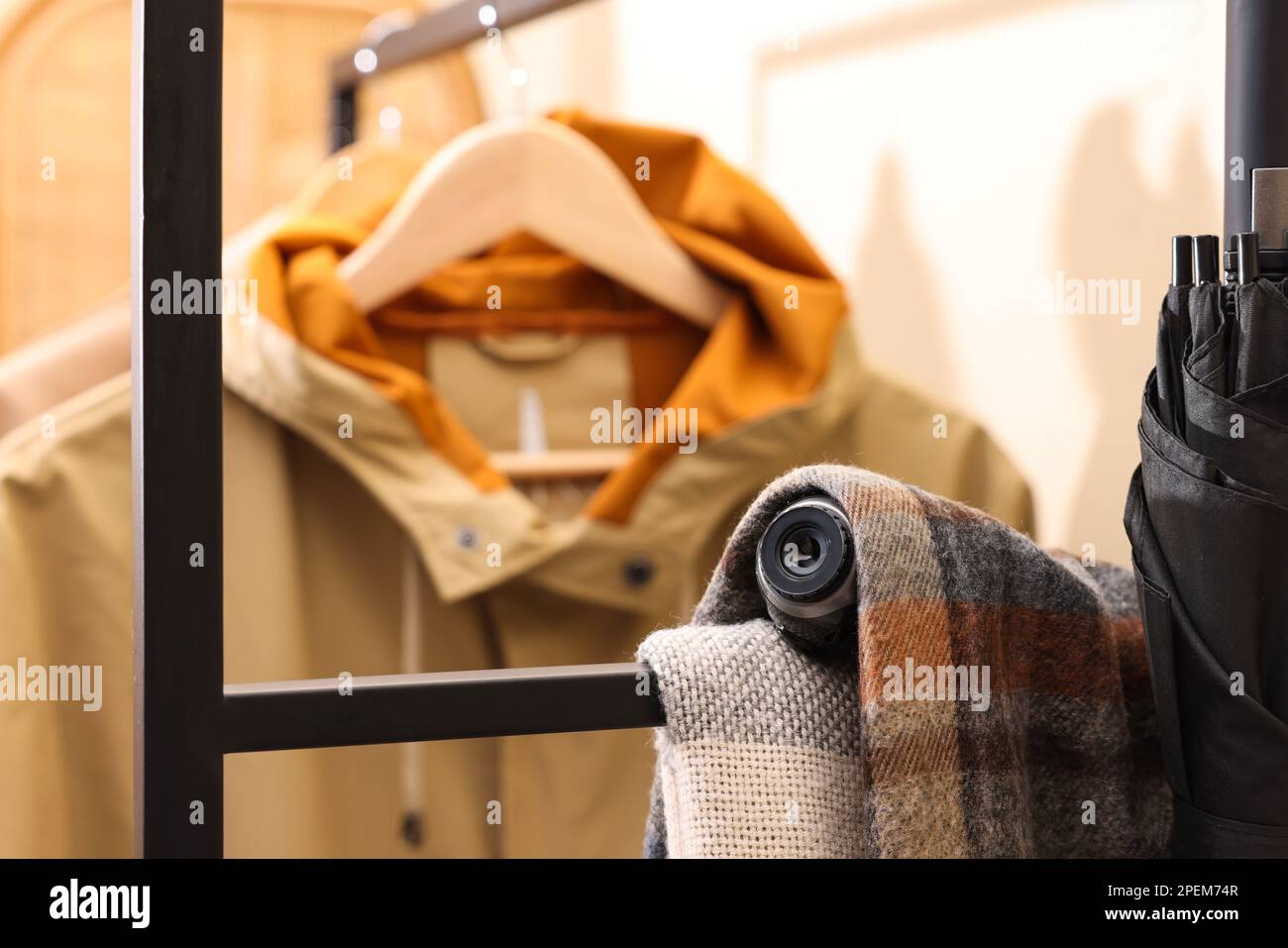 Camera hidden under scarf in wardrobe closet. Space for text Stock ...