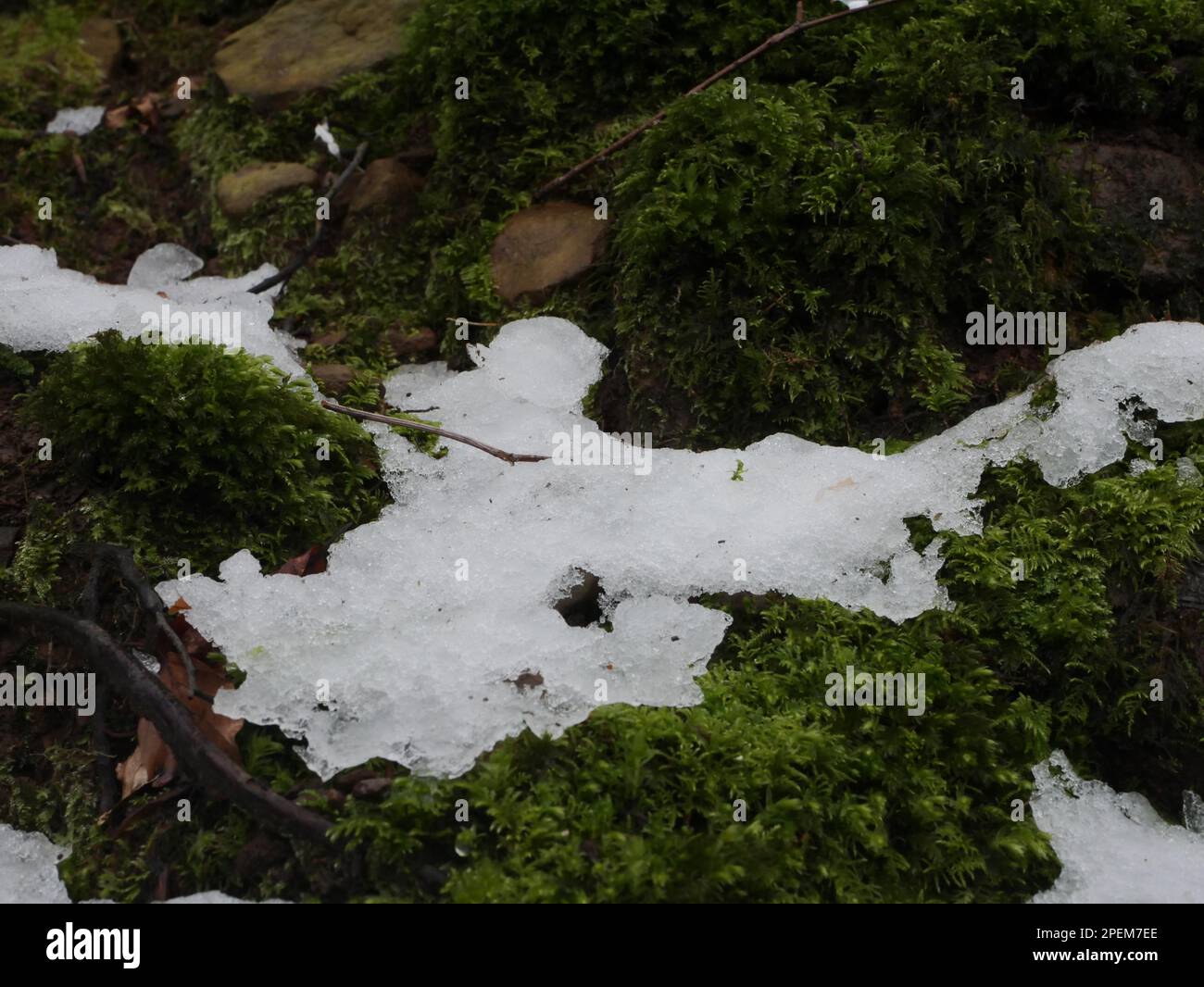 A scenic mountain landscape featuring an icy blanket of snow, rugged ...