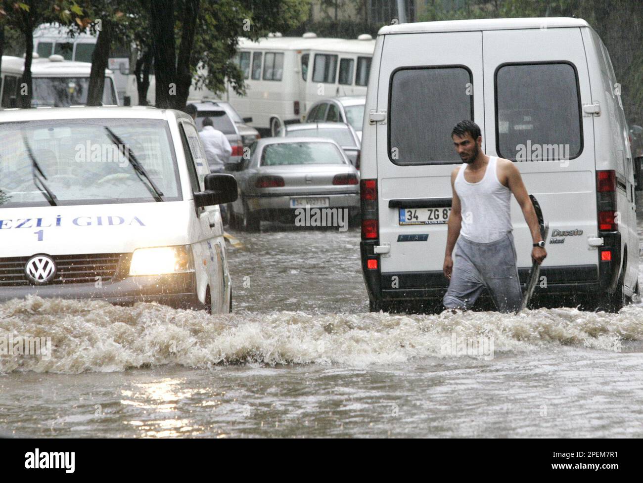 A Turkish man struggles with flood waters in Istanbul, Turkey, Thursday ...