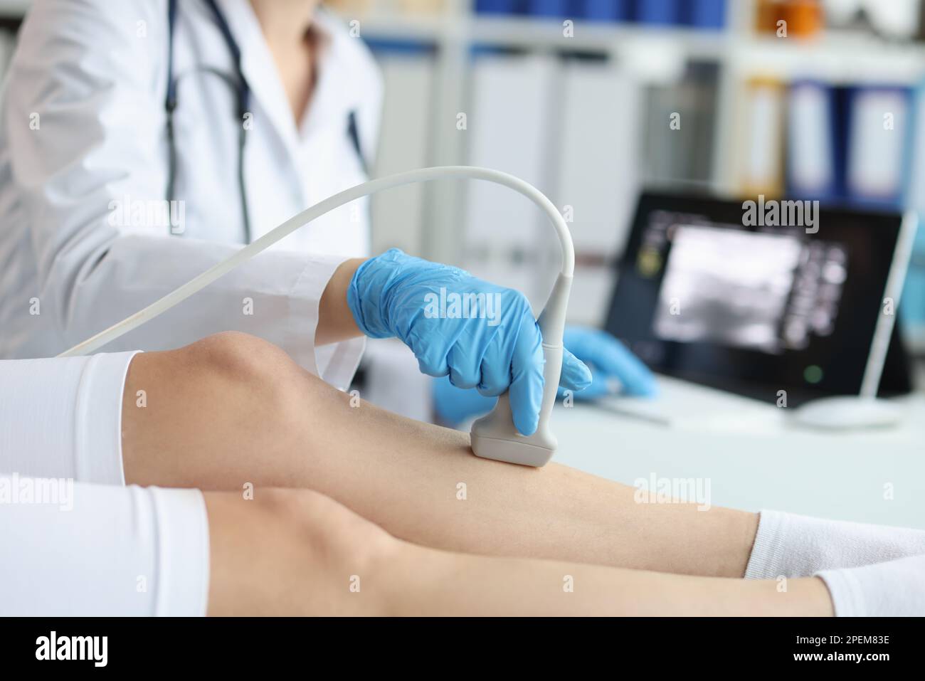 Doctor makes ultrasound scan of knees and legs of woman Stock Photo - Alamy