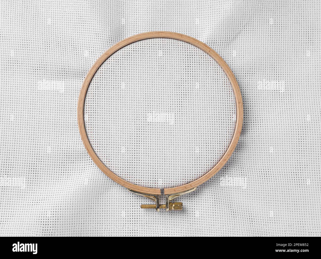 Embroidery hoop with white fabric stretched as background, top view ...
