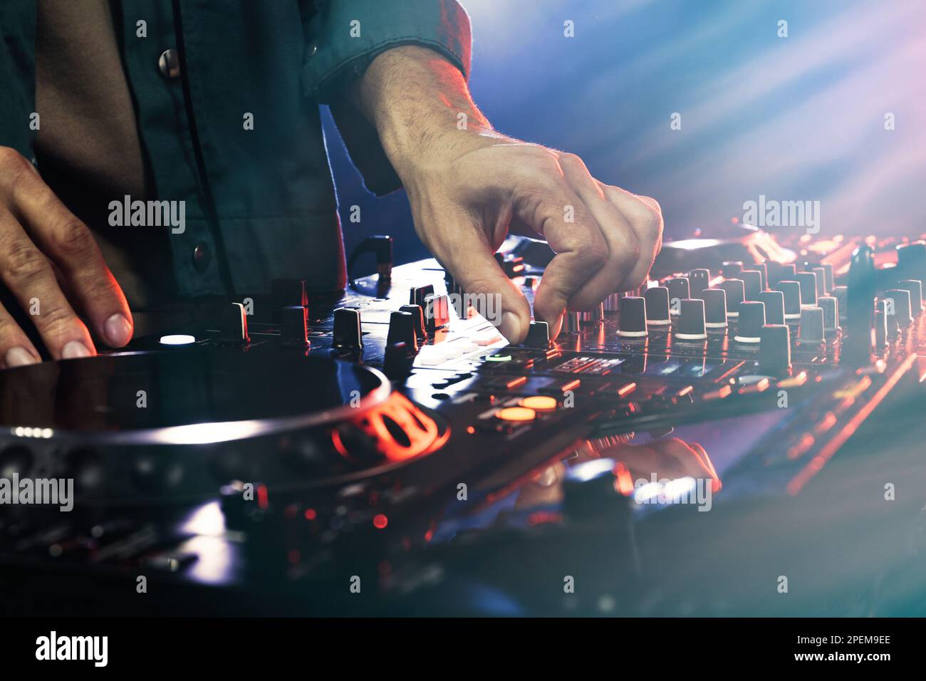 DJ creating music on modern console mixer in night club, closeup Stock ...