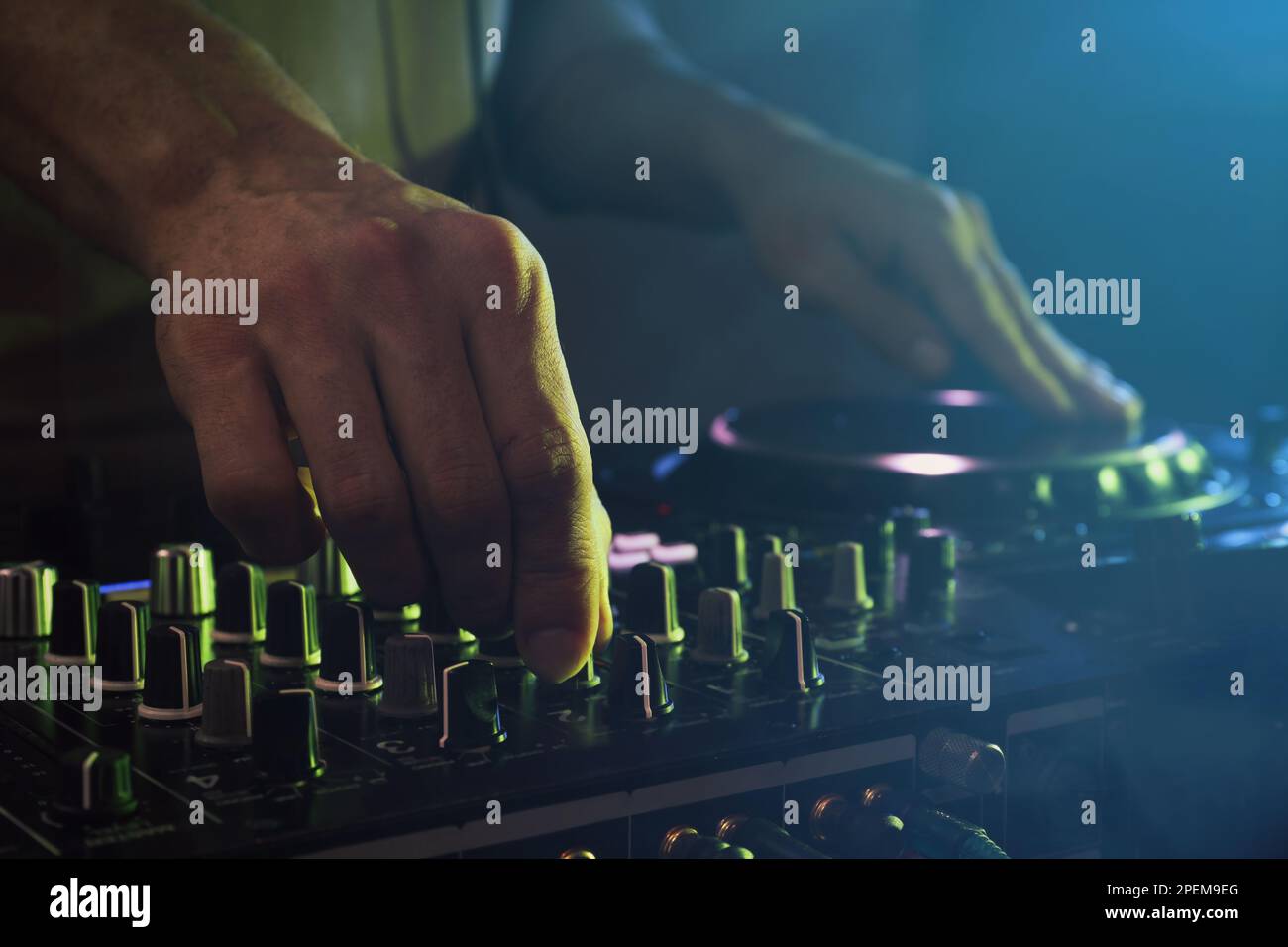 DJ creating music on modern console mixer in night club, closeup Stock ...