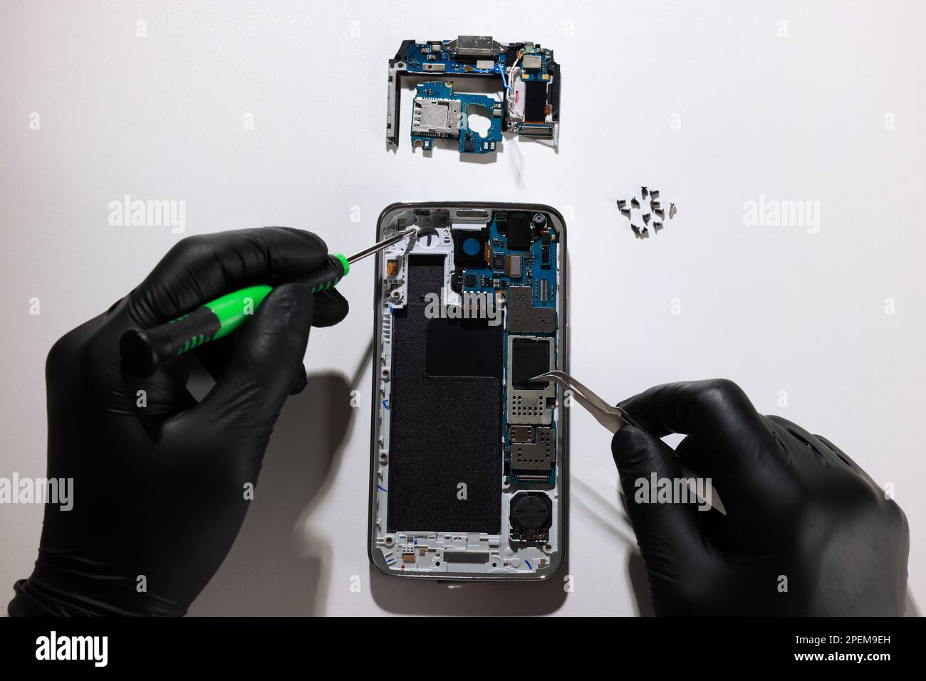 Technician repairing broken smartphone at white table, top view Stock ...