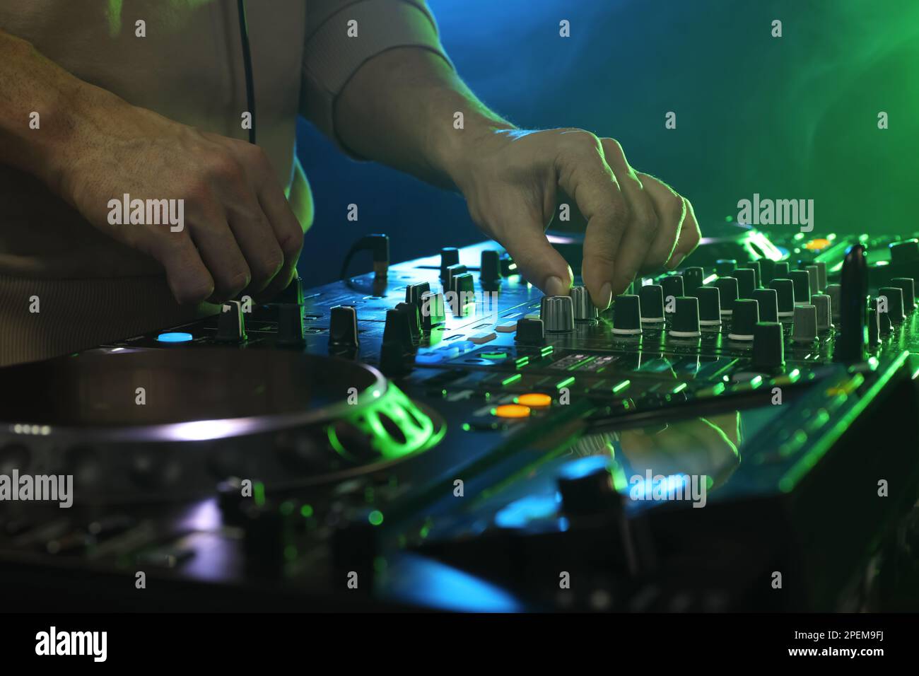 DJ creating music on modern console mixer in night club, closeup Stock ...