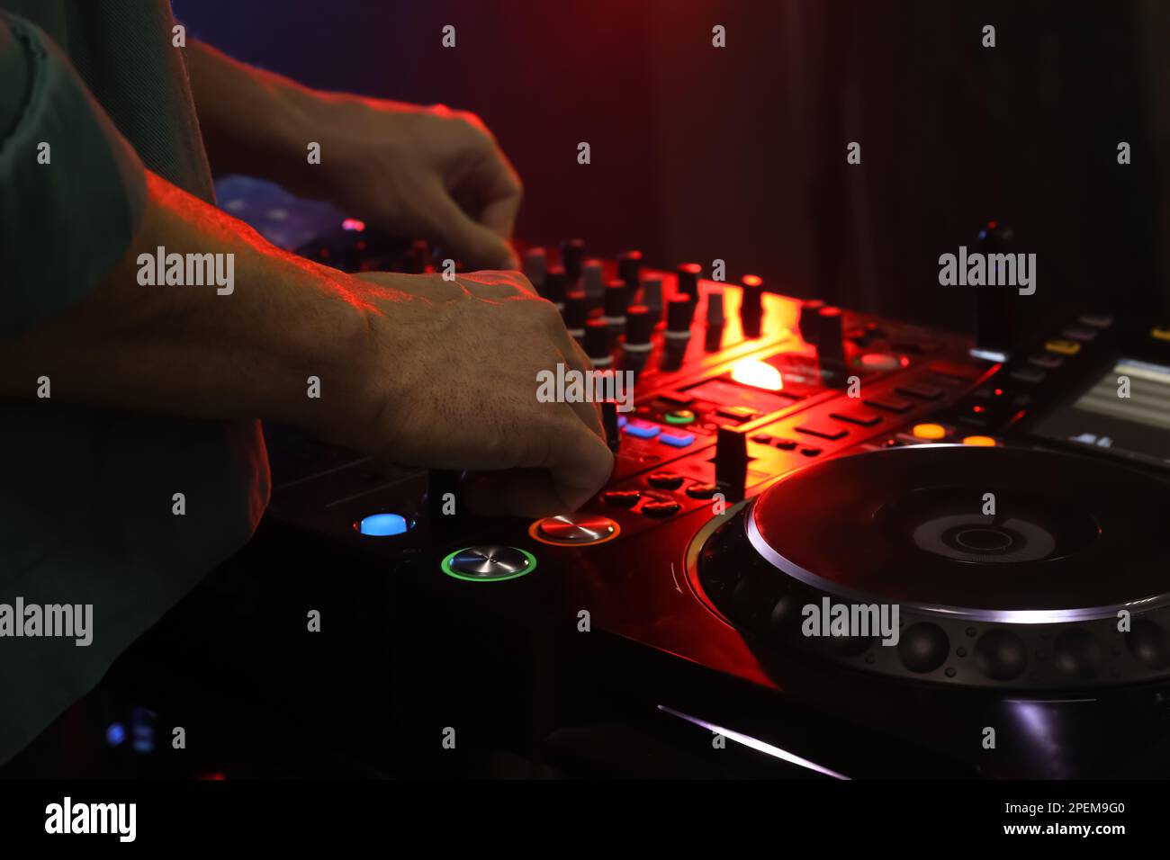 DJ creating music on modern console mixer in night club, closeup Stock ...