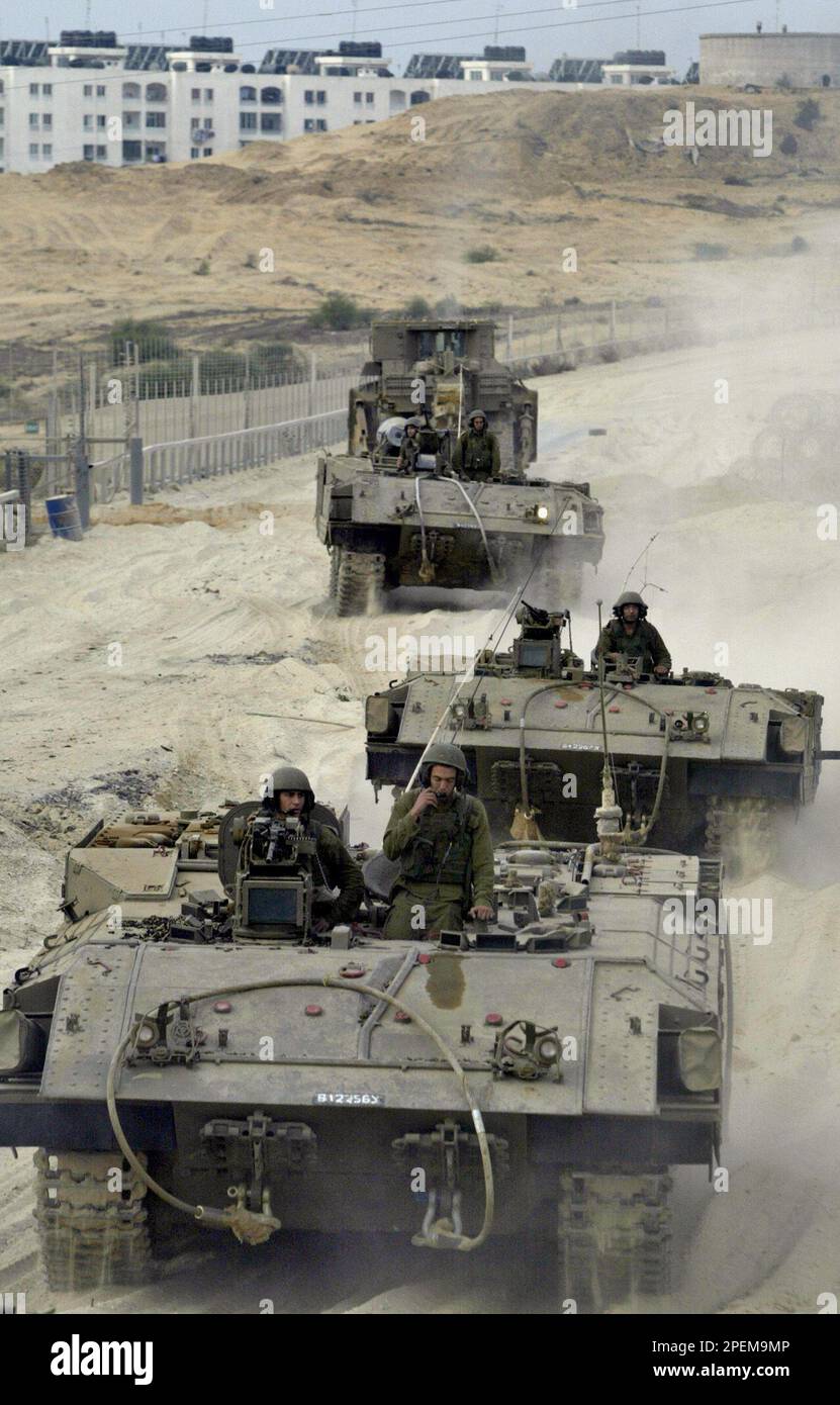 Israeli army armored vehicles move from the Palestinian town of Beit ...