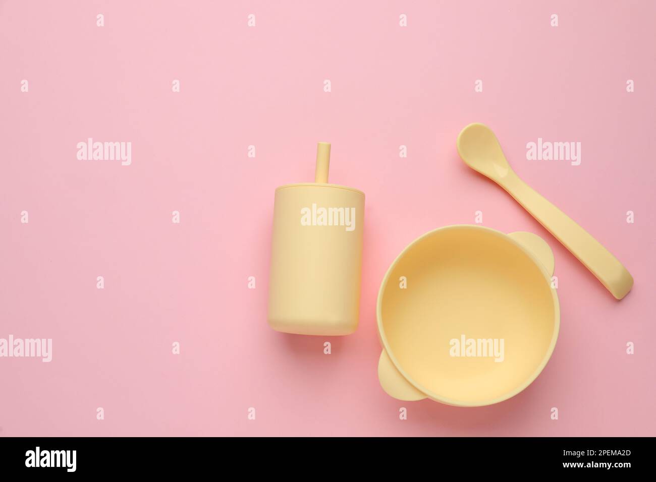 Set of plastic dishware on pink background, flat lay with space for ...