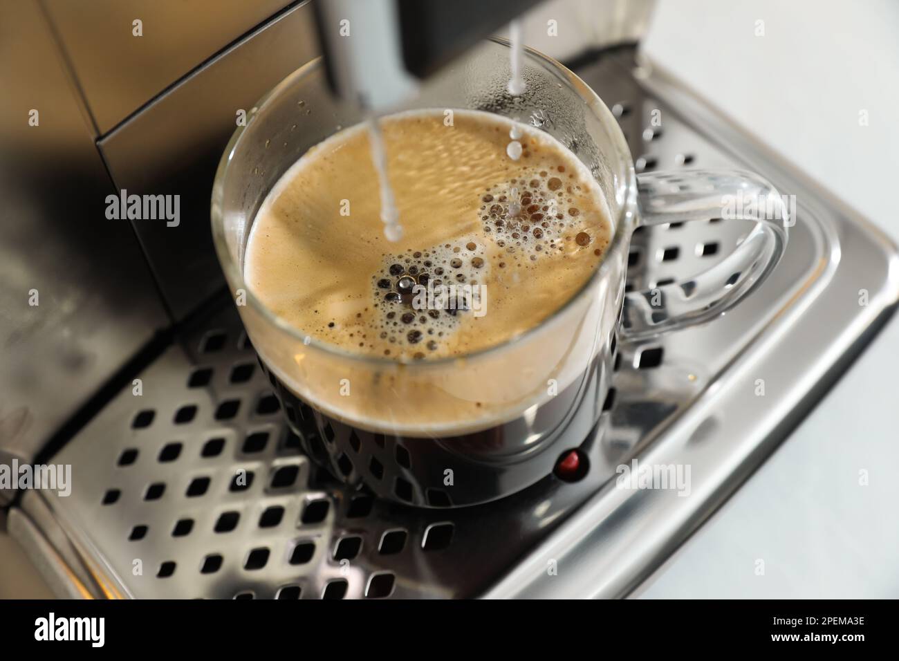 Modern coffee machine making espresso into cup, closeup Stock Photo - Alamy