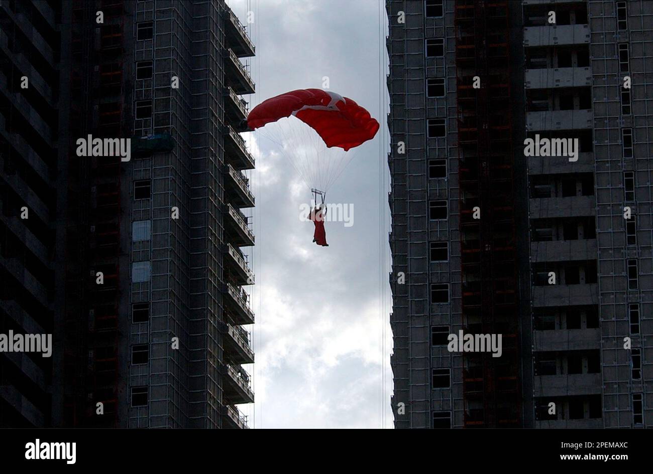 A base jumper parachutes between buildings under construction Tuesday ...