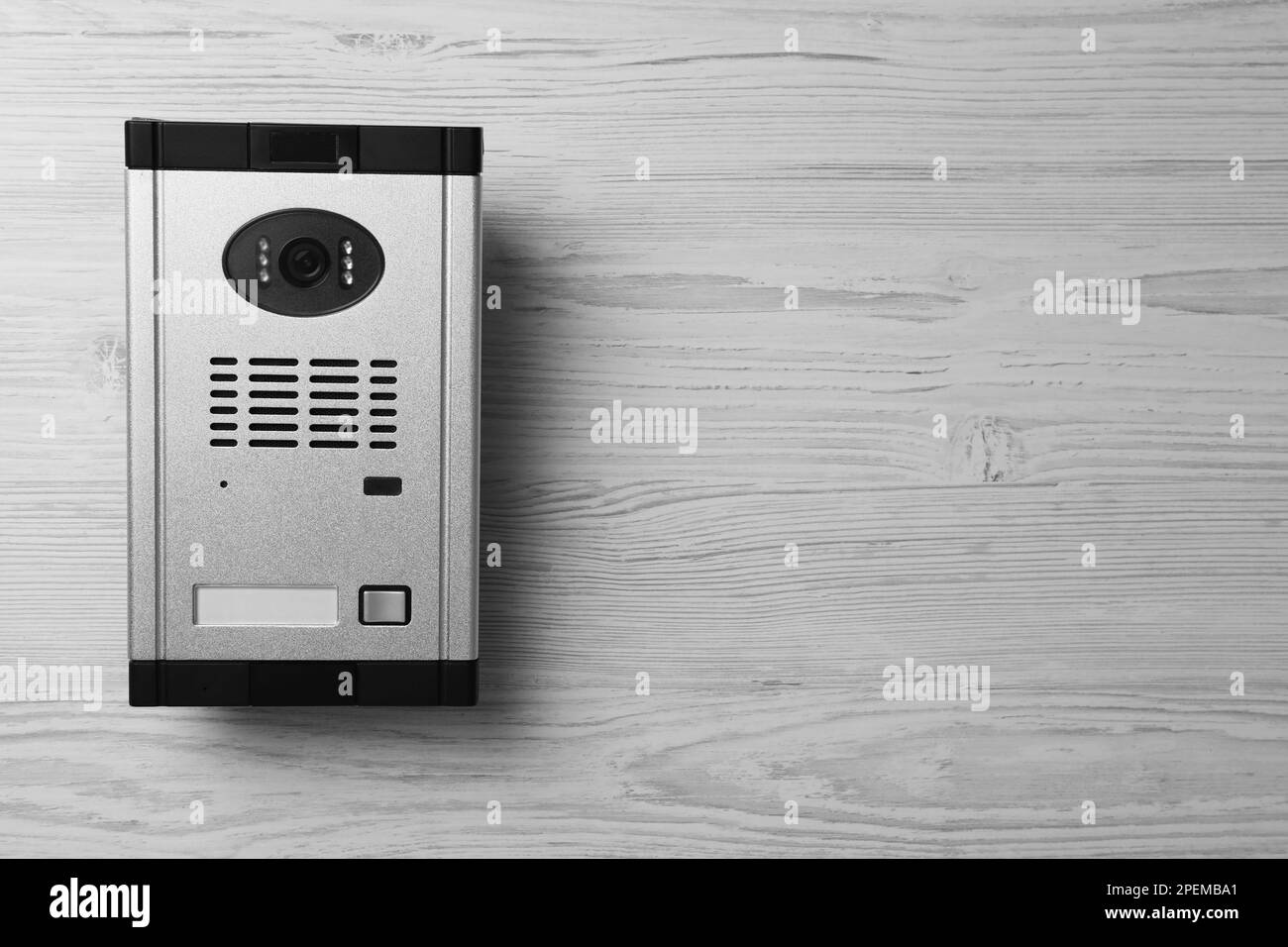 Modern intercom system with camera on white wooden background, top view ... Modern intercom system with camera on white wooden background, top view ...