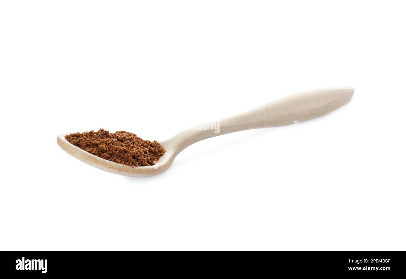 Spoon with nutmeg powder on white background Stock Photo - Alamy