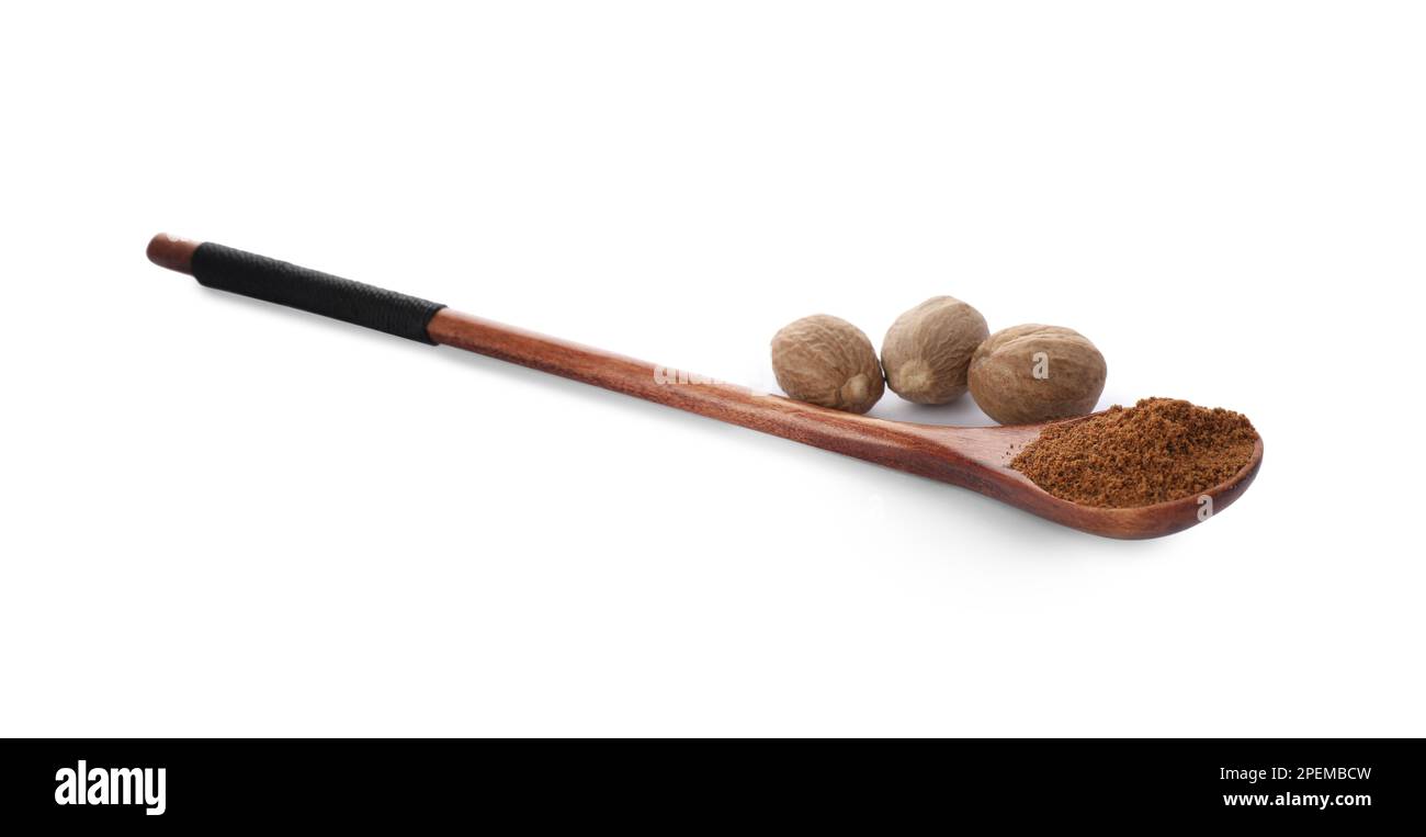 Wooden spoon of nutmeg powder and seeds on white background Stock Photo ...
