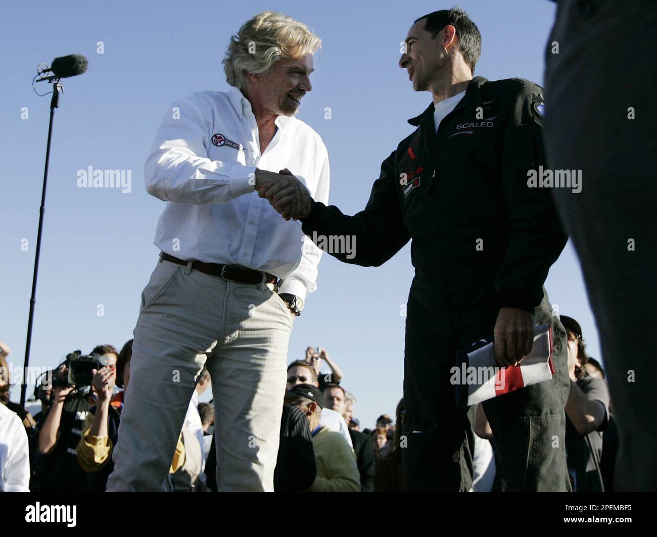 Richard Branson, left, shakes hands with astronaut Brian Binnie ...