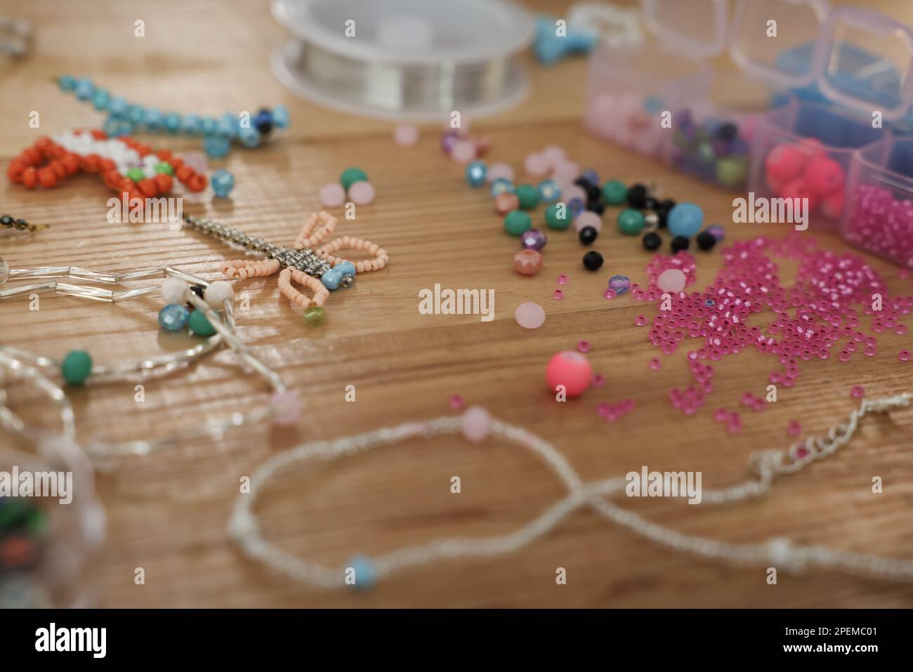 Beautiful handmade beaded jewelry and supplies on wooden table Stock ...