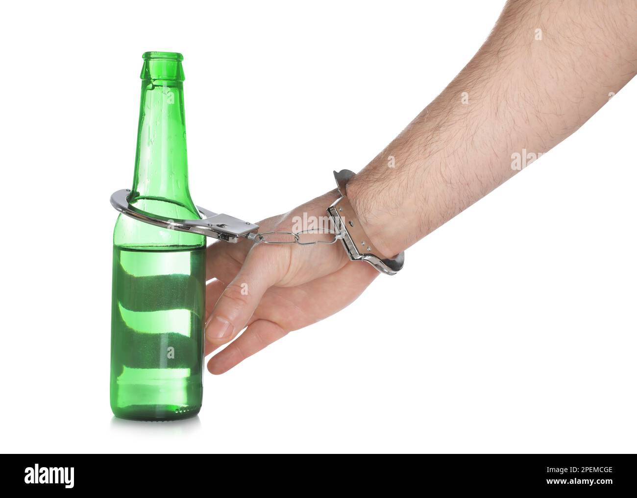 Man in handcuffs with bottle of beer on white background, closeup ...