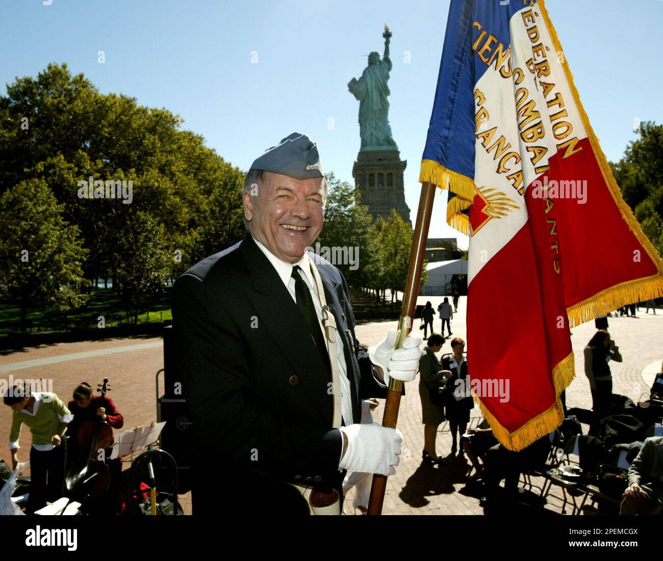 Joseph Crouzilhat holds a French war veterans organization flag on ...