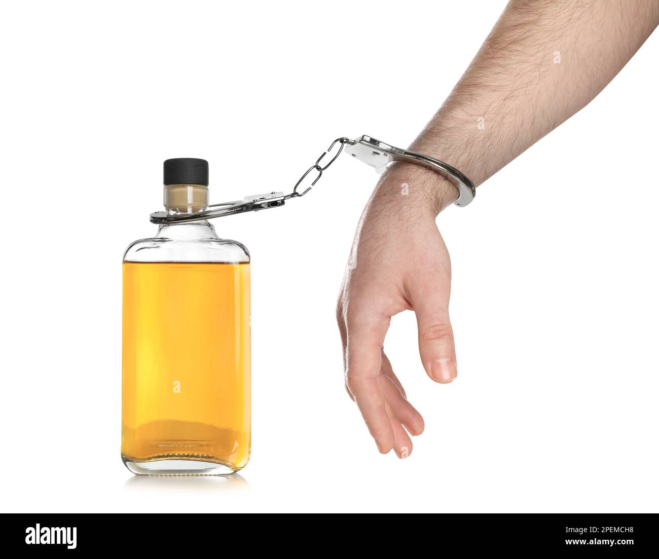 Addicted man in handcuffs with bottle of alcoholic drink on white ...