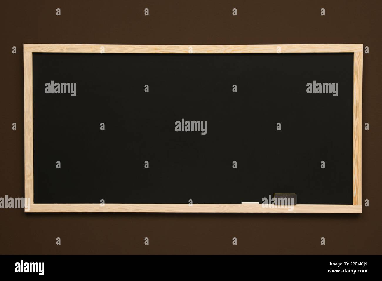 Clean black chalkboard hanging on brown wall Stock Photo - Alamy